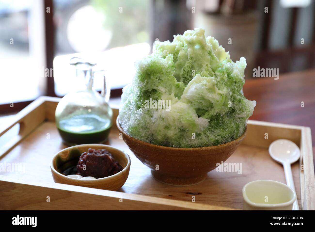 Delicious Japanese sweet shaved ice green tea on wooden table in ...