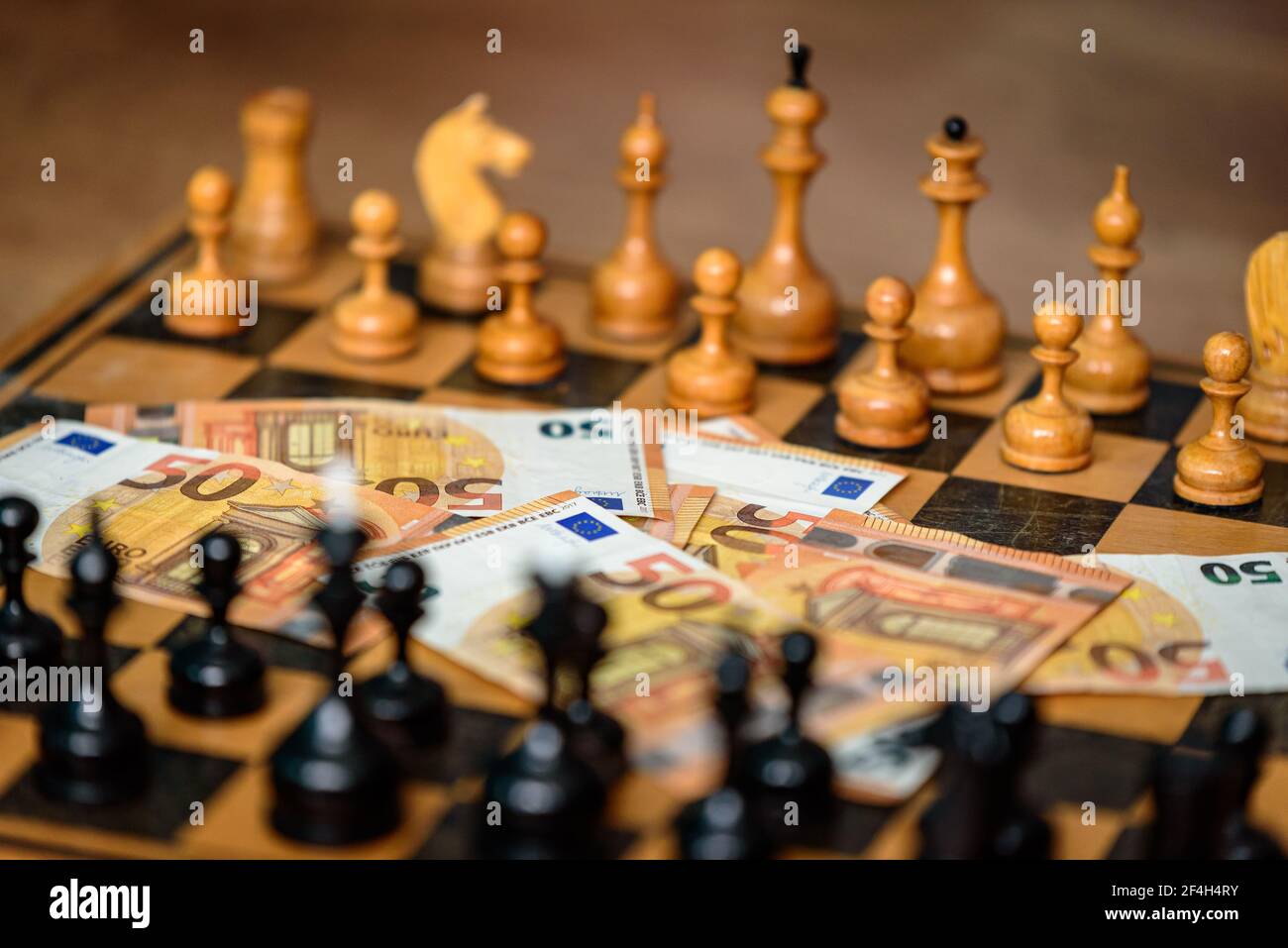 a chess table with figures and real money that will be played or won as ...