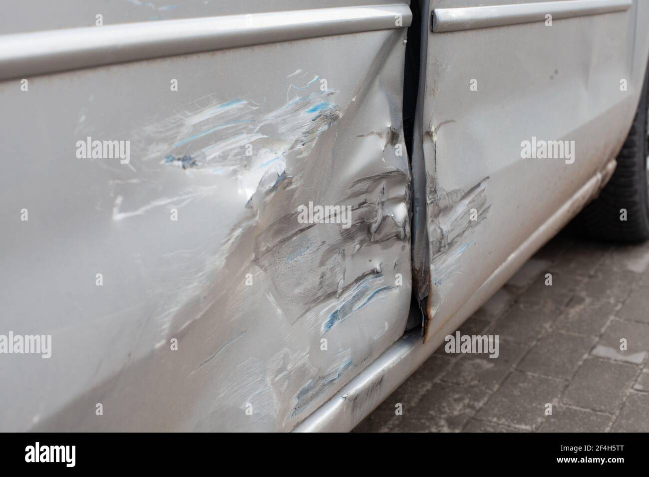 Body of car get damage by accident. Silver car with a large dent in the ...