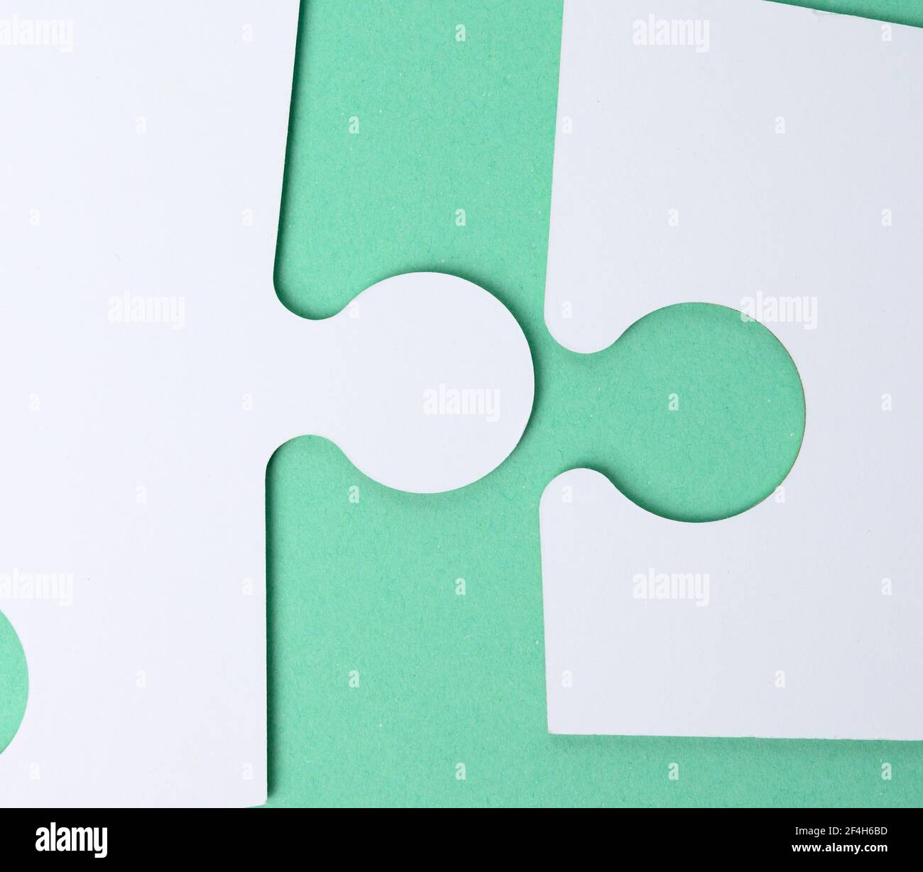 white paper puzzles on a green background, connection, close up Stock ...