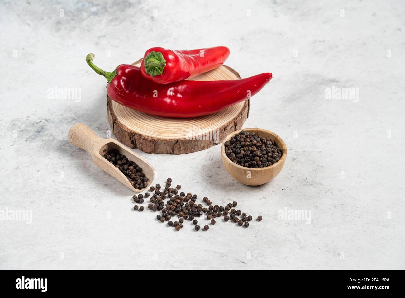 Hot chili peppers and pepper grains on marble background Stock Photo ...