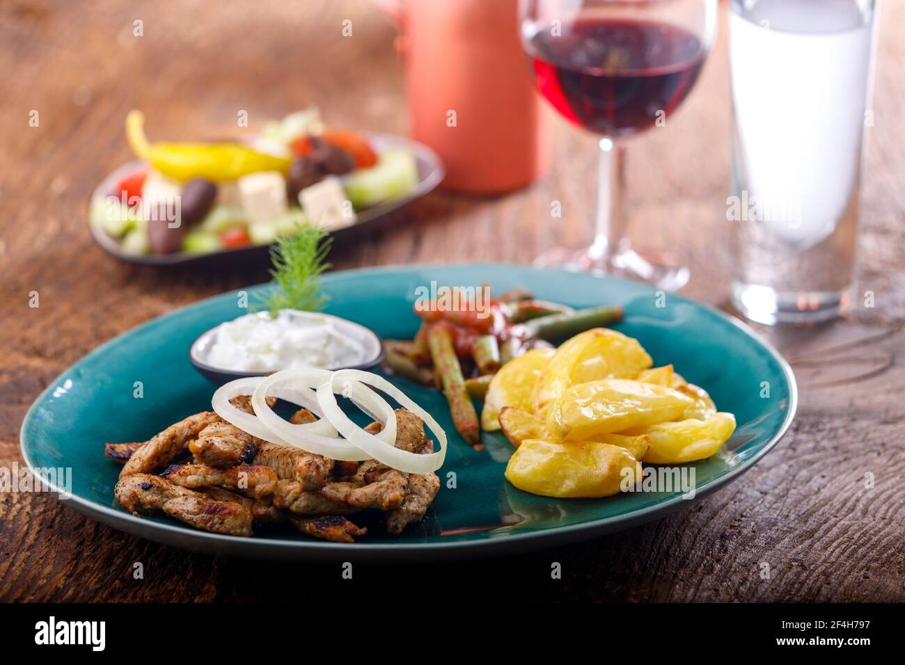 greek gyros with french fries on wood Stock Photo - Alamy