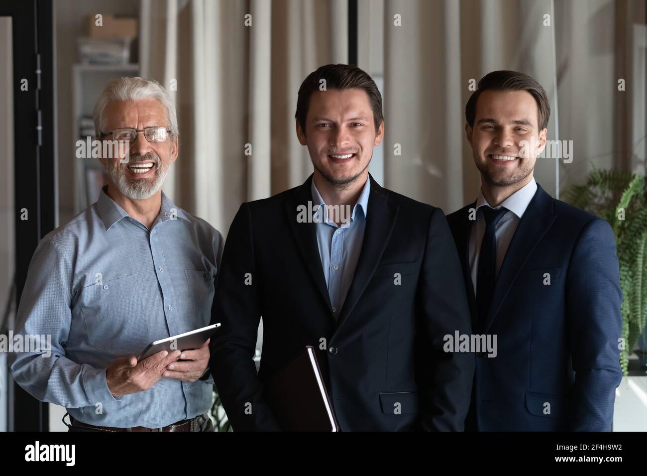Portrait of smiling diverse male employees show unity Stock Photo - Alamy