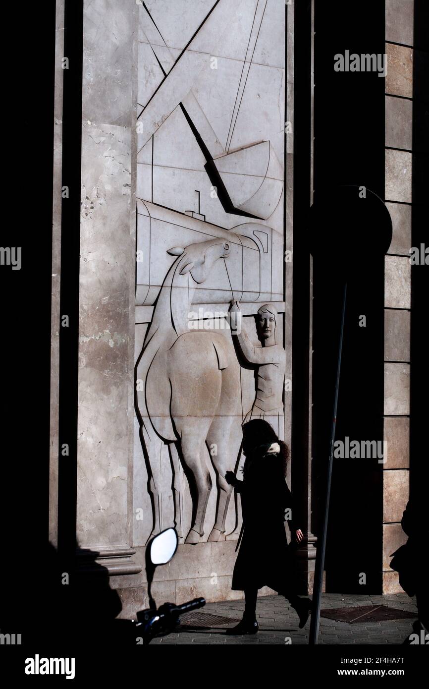 Woman walking past negative bas relief mural, Barcelona, Spain Stock ...