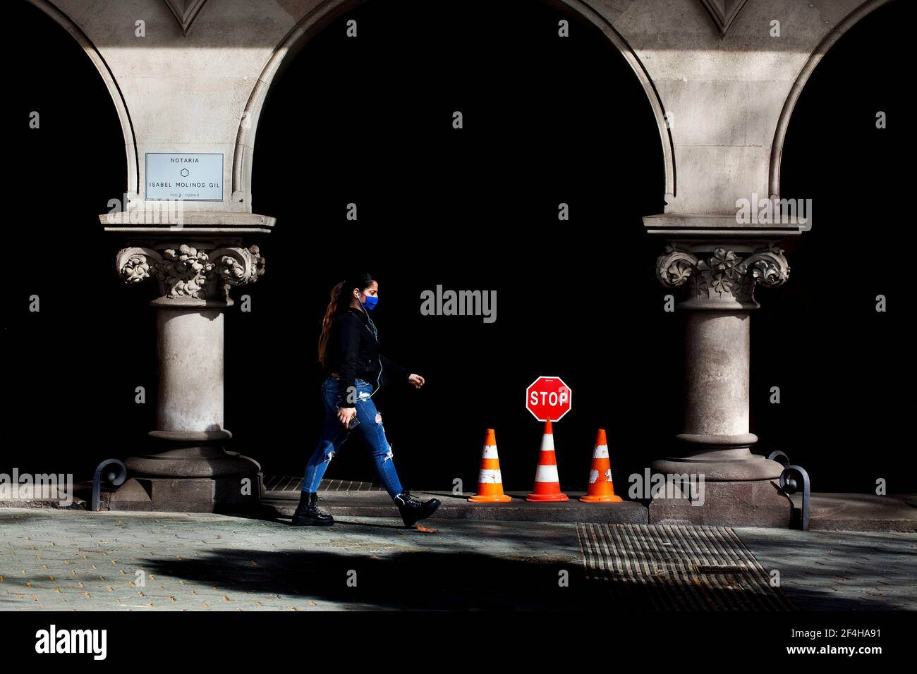 Woman walking past sign hi-res stock photography and images - Alamy