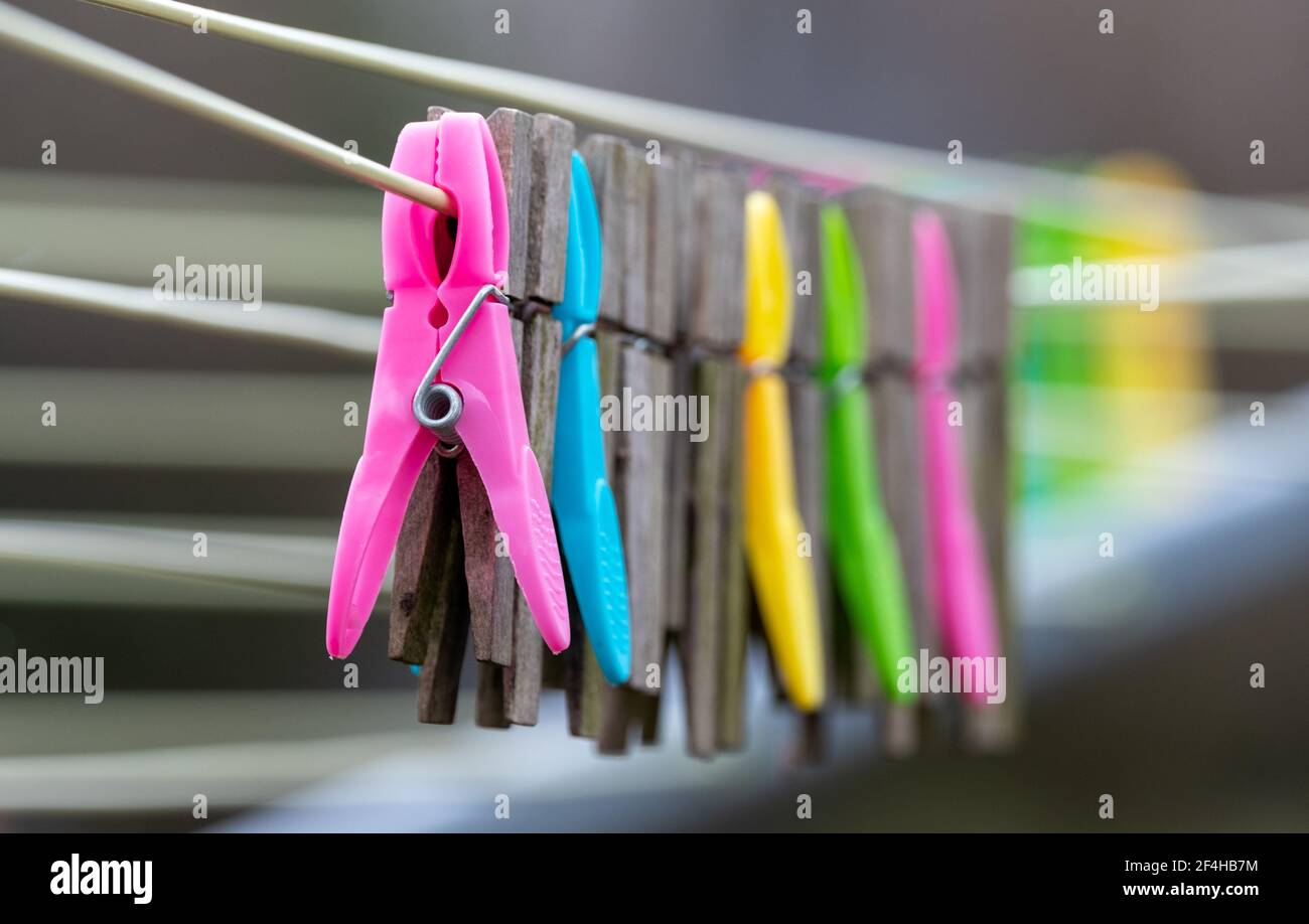 Plastic and wooden clothes pegs hanging from a clothes line. Air drying ...