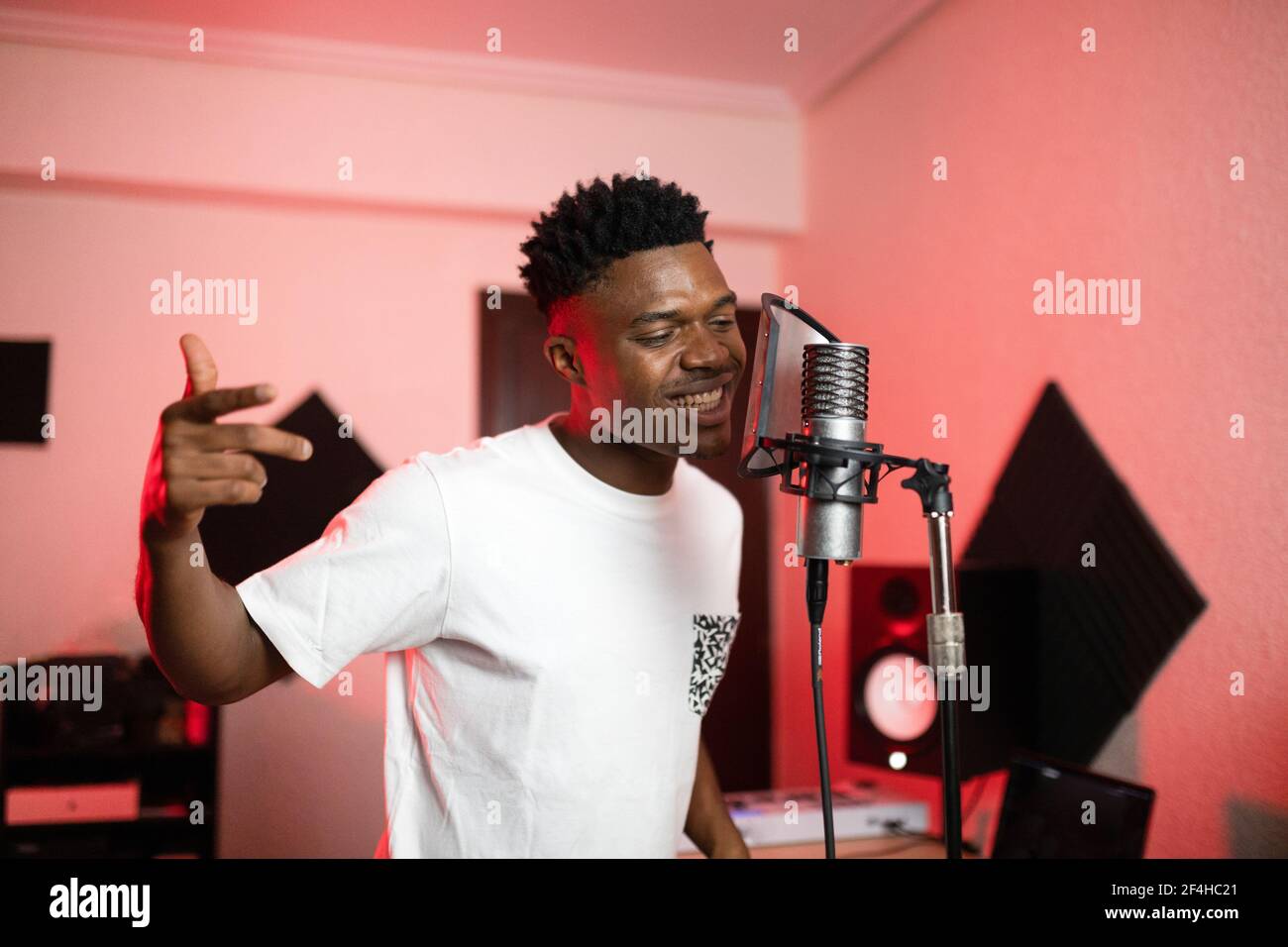 Young African American vocalist with open mouth and modern haircut ...