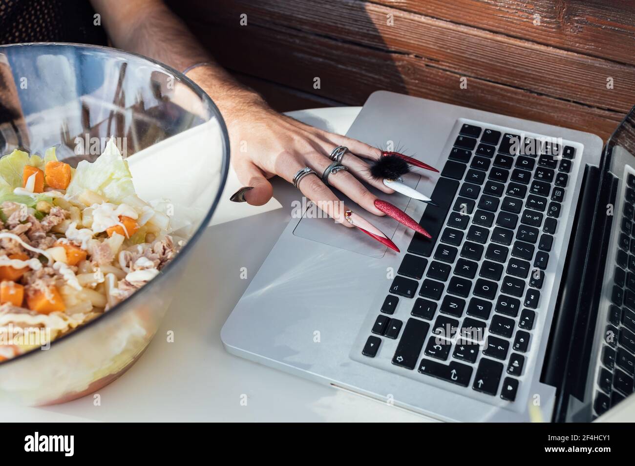 Cropped unrecognizable transgender man surfing internet on netbook at ...