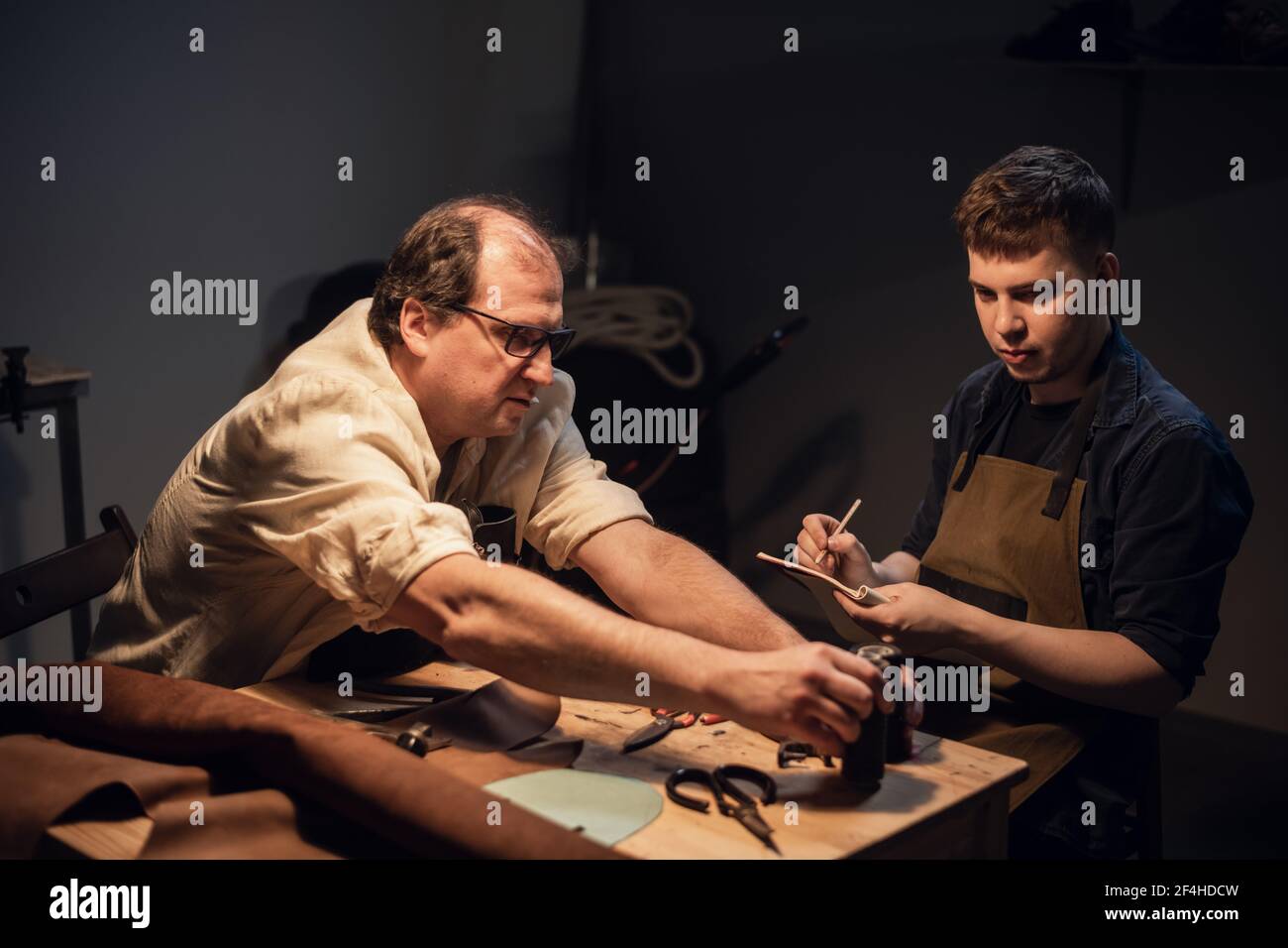 a respectable elderly shoemaker conducts a master class for a young boy ...