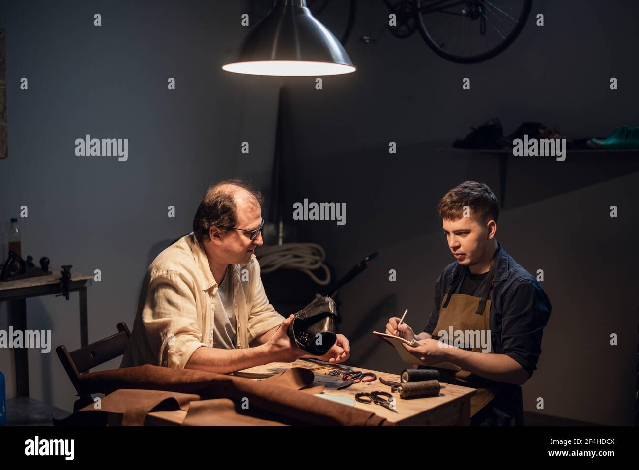 father-shoemaker prepares a successor in the family business of manual ...