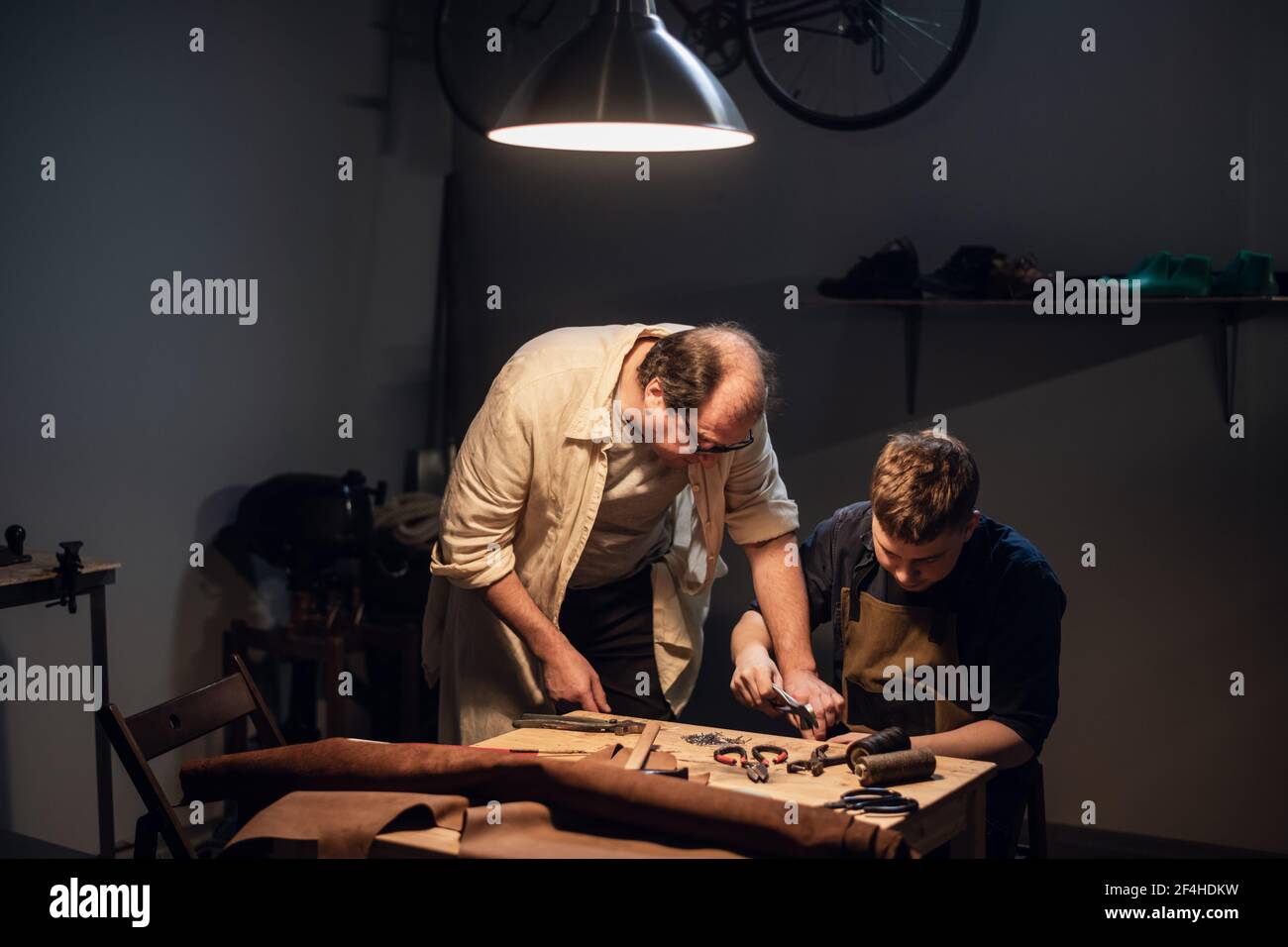 a respectable elderly shoemaker conducts a master class for a young boy ...