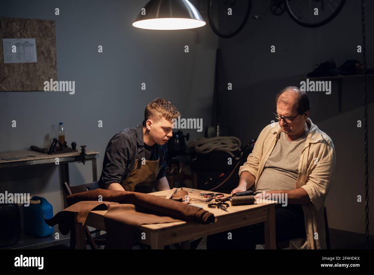 a respectable elderly shoemaker conducts a master class for a young boy ...
