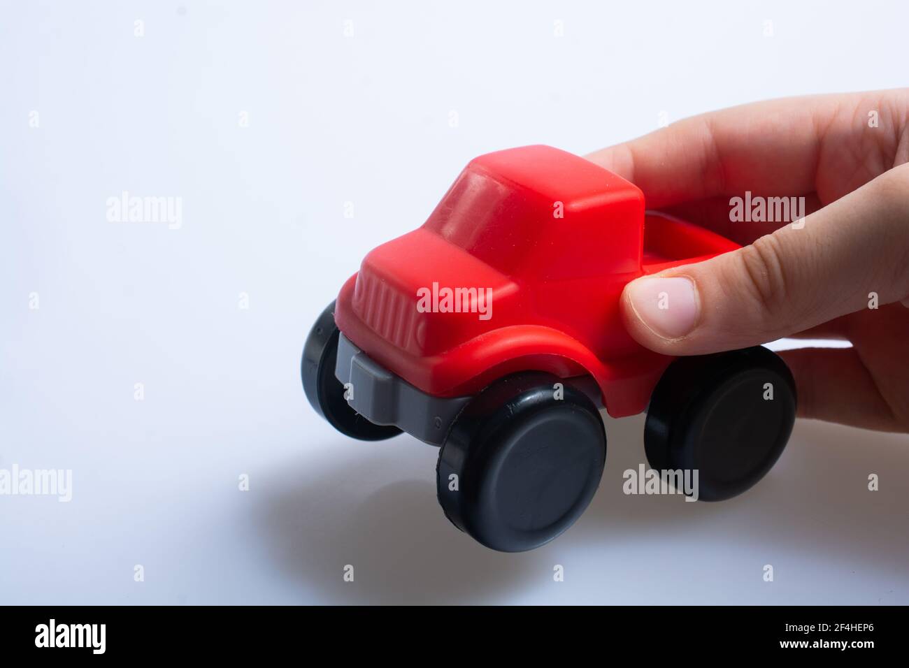 Hands hold a red toy lorry truck Stock Photo - Alamy