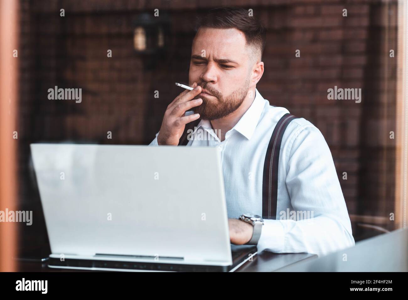 Man smoking cigarette in restaurant hi-res stock photography and images ...