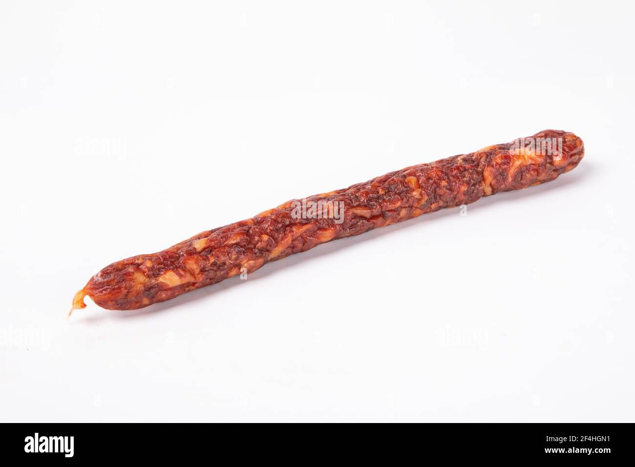 A long smoked sausage isolated on white background Stock Photo - Alamy