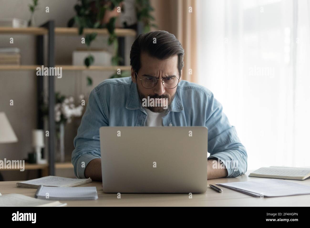 Confused student looking laptop screen hi-res stock photography and ...