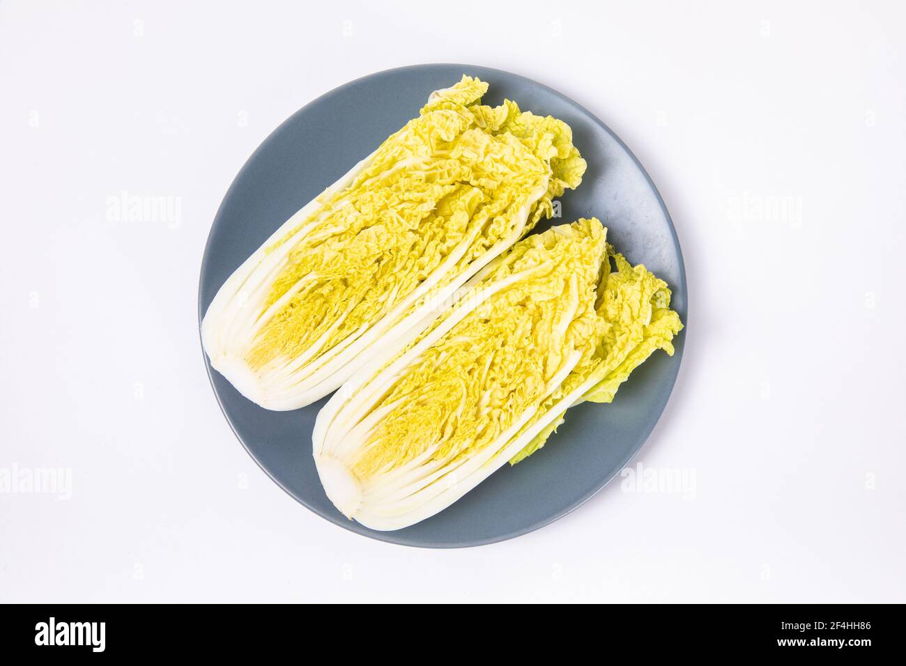 A top view of fresh chinese cabbage on the plate isolated on white ...