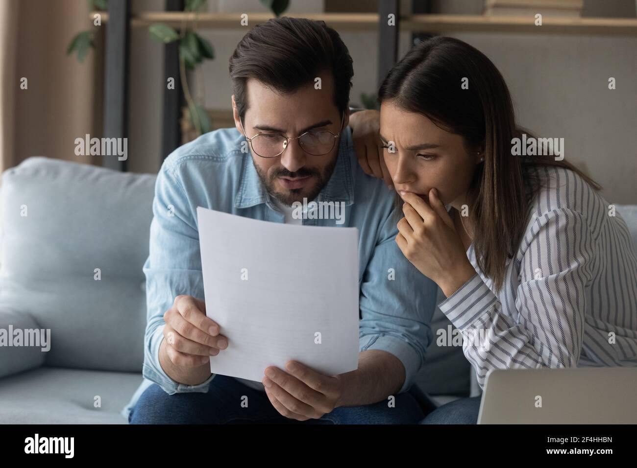 Close up puzzled focused couple reading letter together, bad news Stock ...