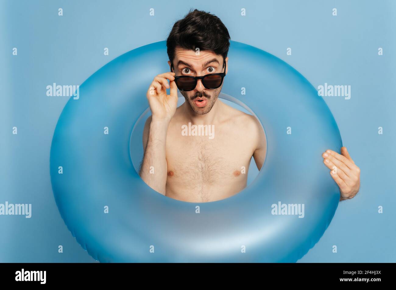 Amazed excited shirtless cheerful caucasian foolish young man in a ...