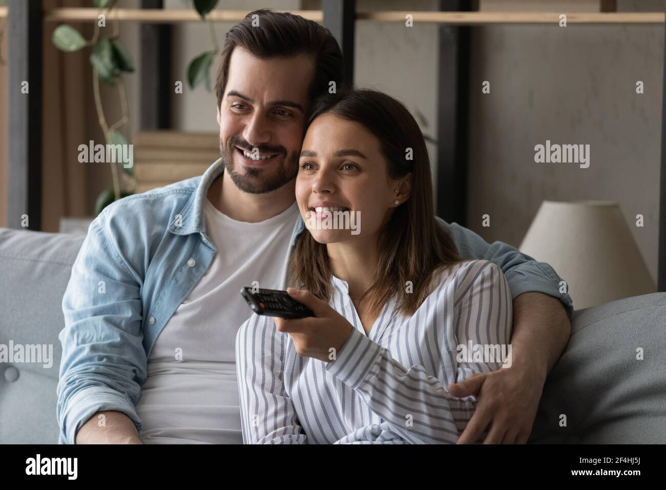 Watching tv using remote controller hi-res stock photography and images ...