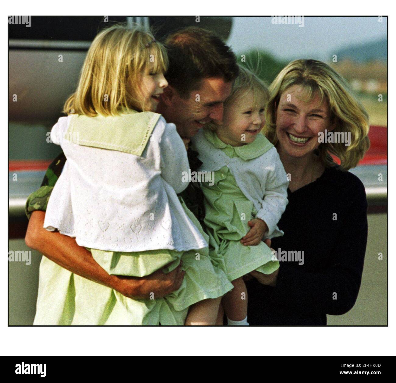 Major Harrison is met by his daughter Philippa (5) and (rt) his wife ...