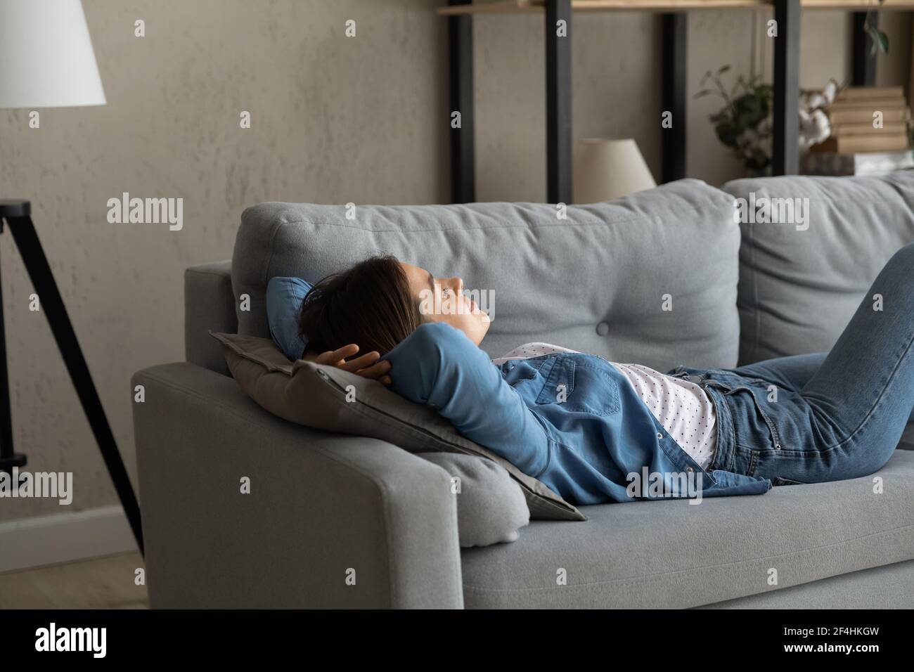 Close up relaxed woman resting, lying on couch at home Stock Photo - Alamy