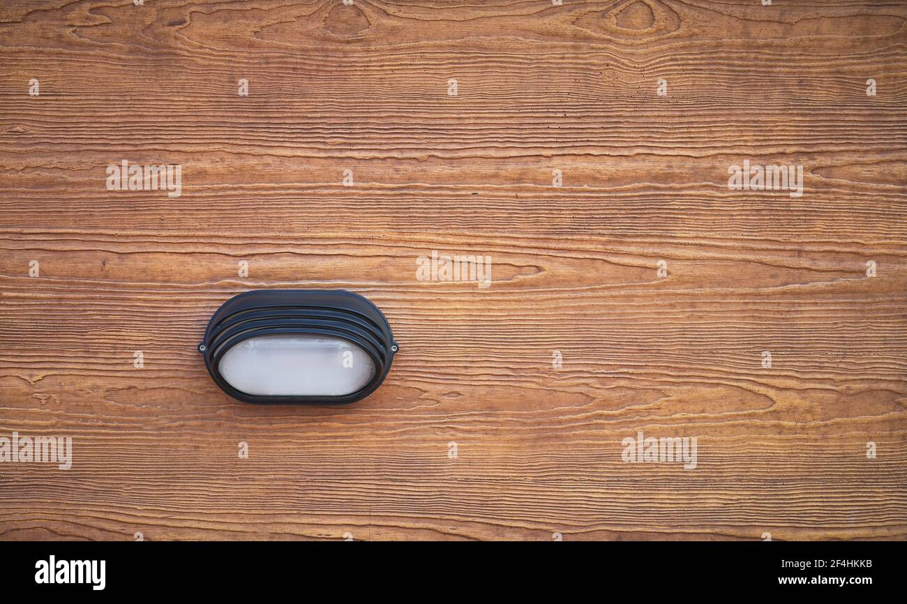 detail of a beacon or signaling light on a concrete wall with wood ...