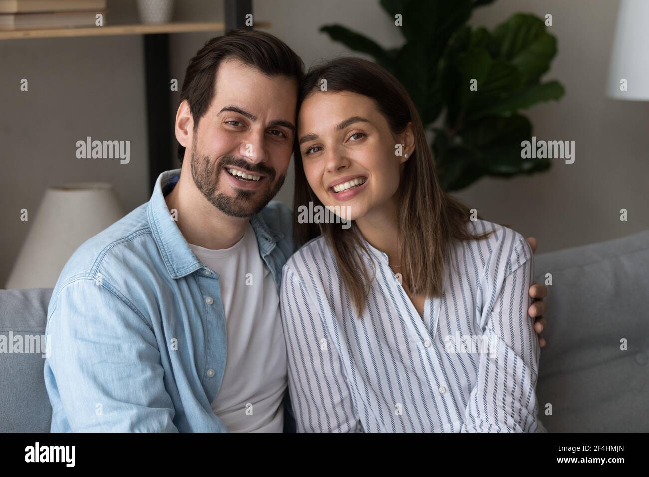 Head shot portrait smiling couple hugging, looking at camera Stock ...