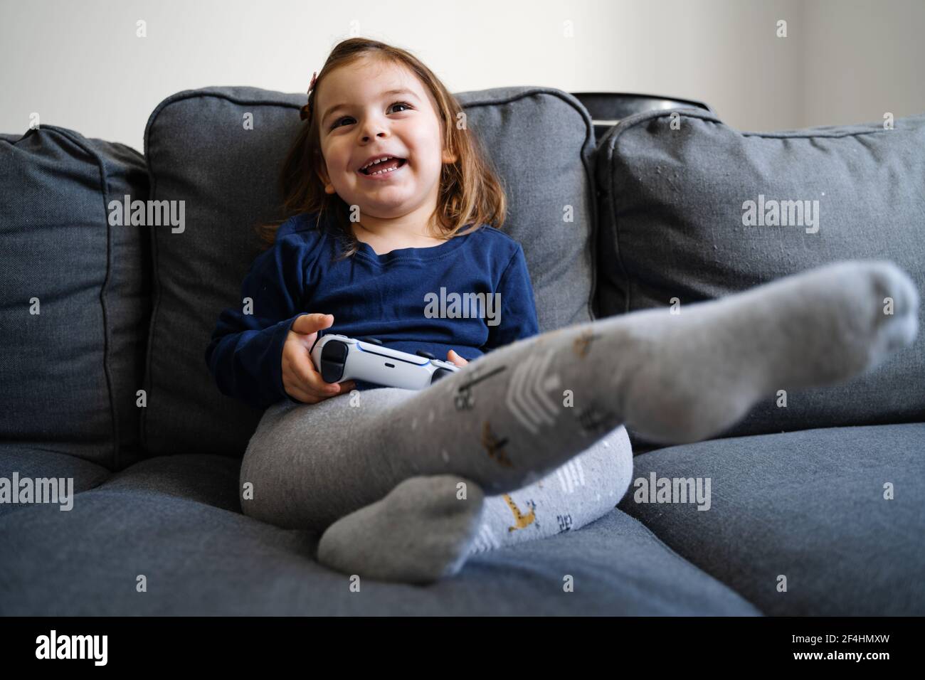 Small child playing video games with gamepad on console. Modern kids ...