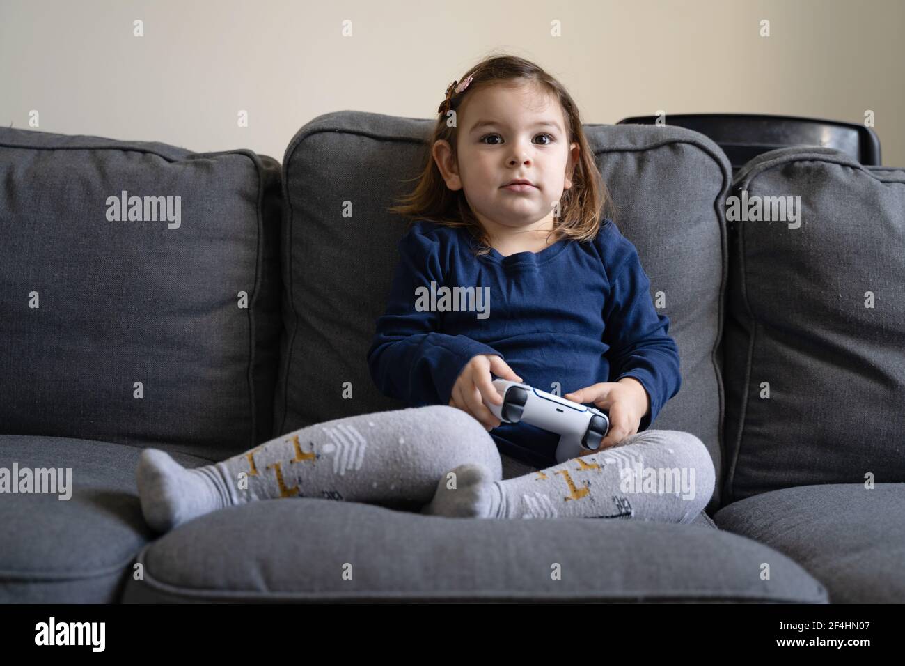 Small child playing video games with gamepad on console. Modern kids ...