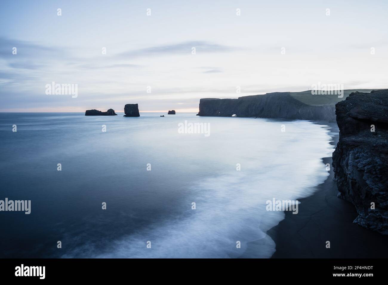 A scenic shot of the black sand Reynisfjara Beach in Vik, Iceland Stock ...