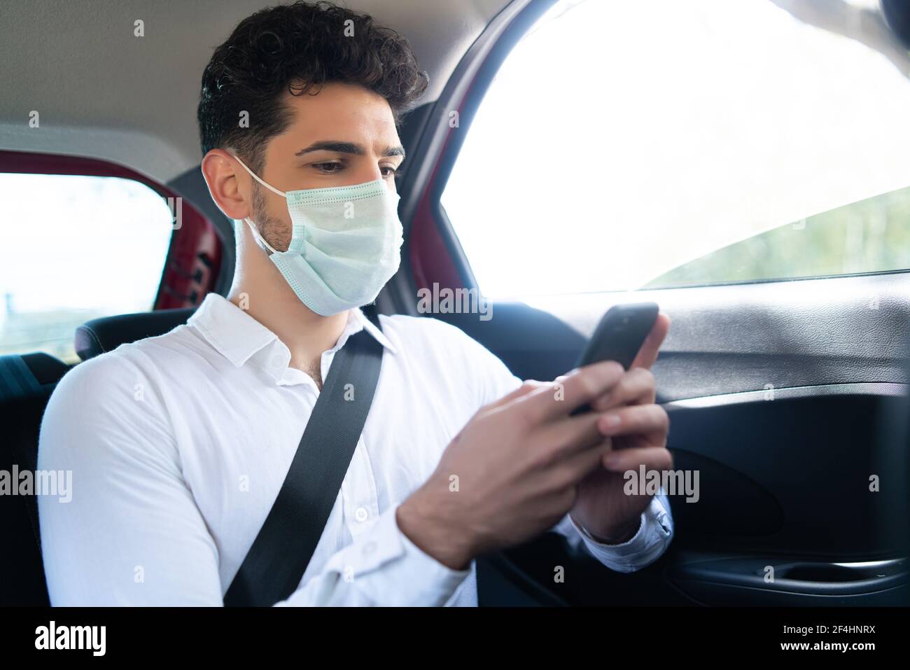 Businessman using mobile phone in car Stock Photo - Alamy