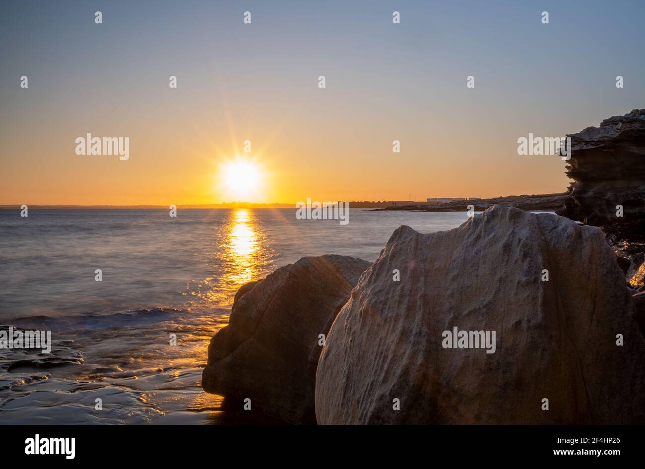 Big orange sunset reflecting on water with orange horizon Stock Photo ...