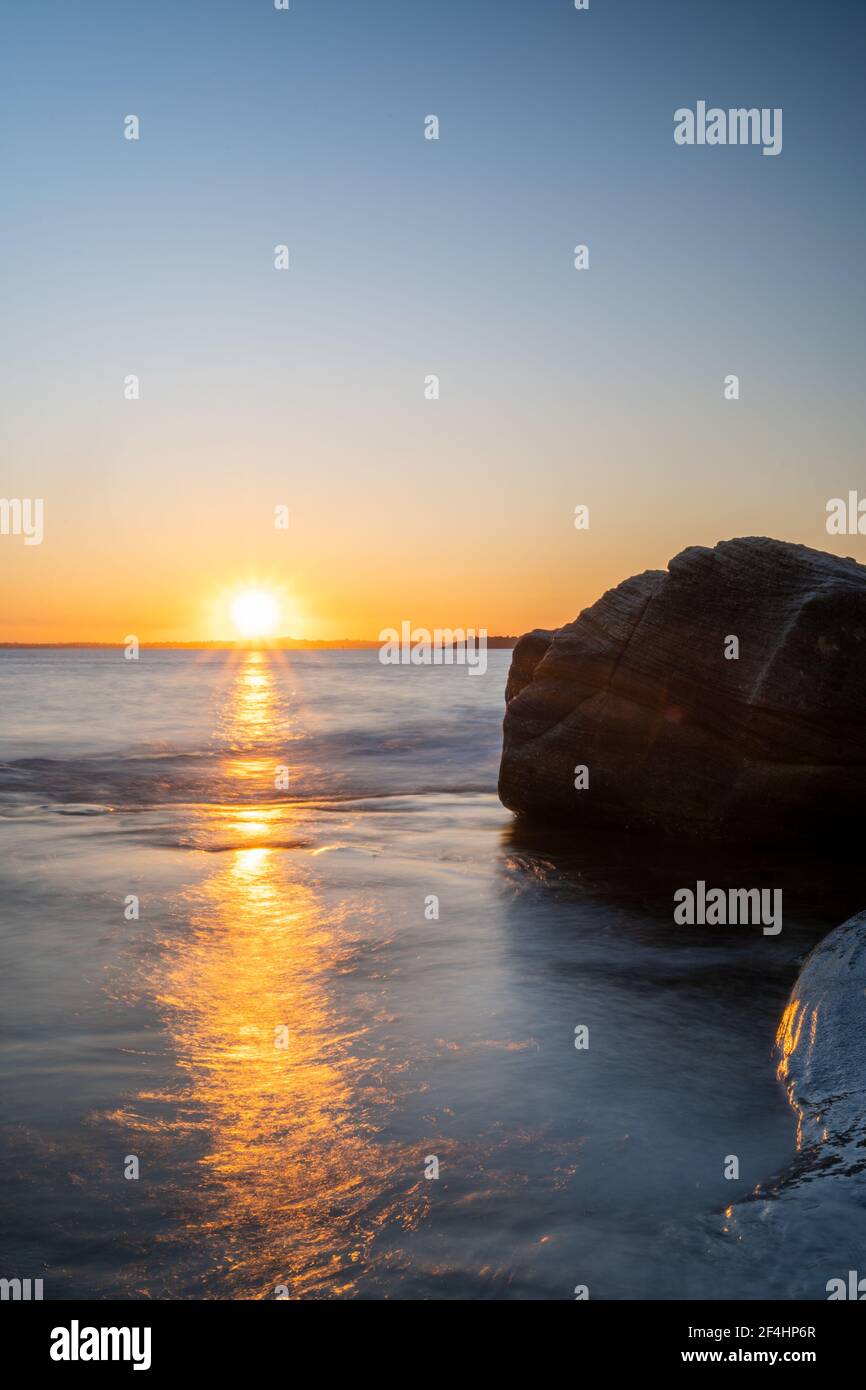 Long exposure sunset shot with rocks Stock Photo - Alamy