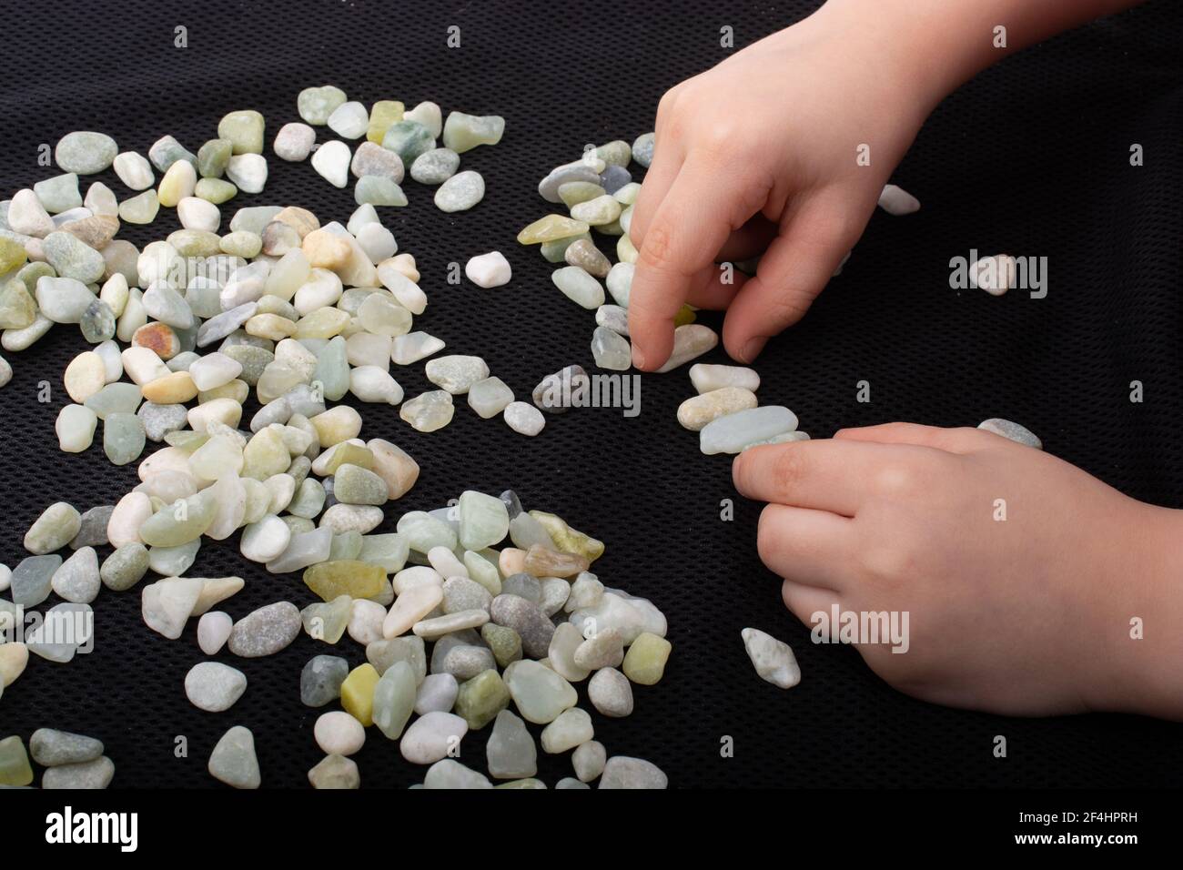 Handful of clean pebbles, gravels in hands Stock Photo - Alamy