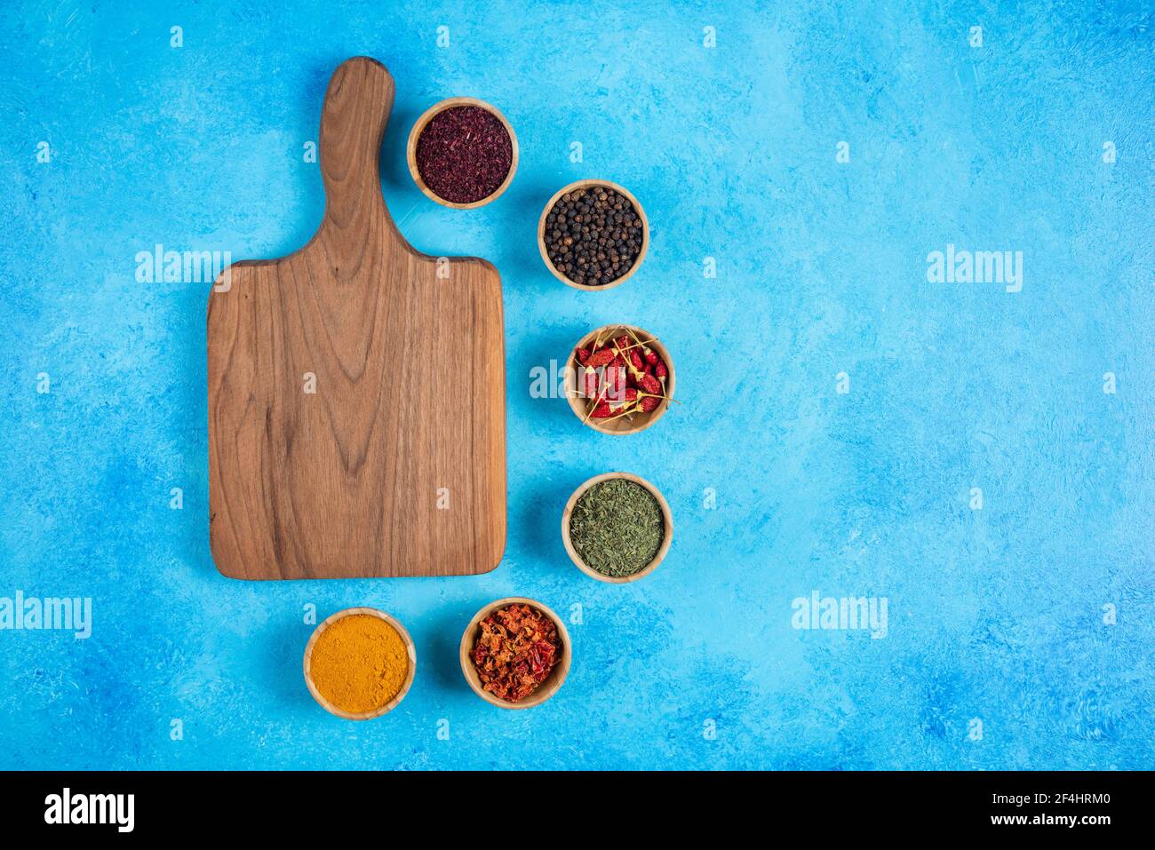 Assortment of organic spices around wooden board Stock Photo - Alamy