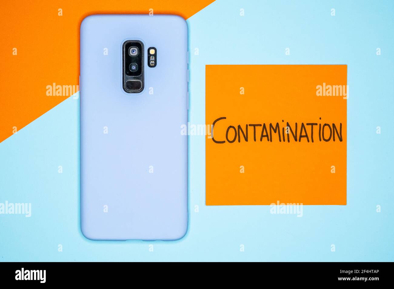 Modern light blue mobile phone on a blue and orange background with a ...