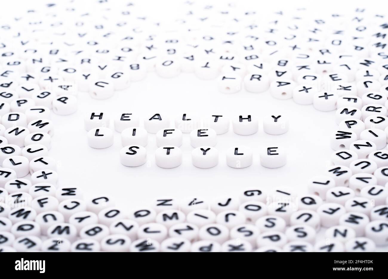 Healthy life style written on a block of letters in a sea of letter ...