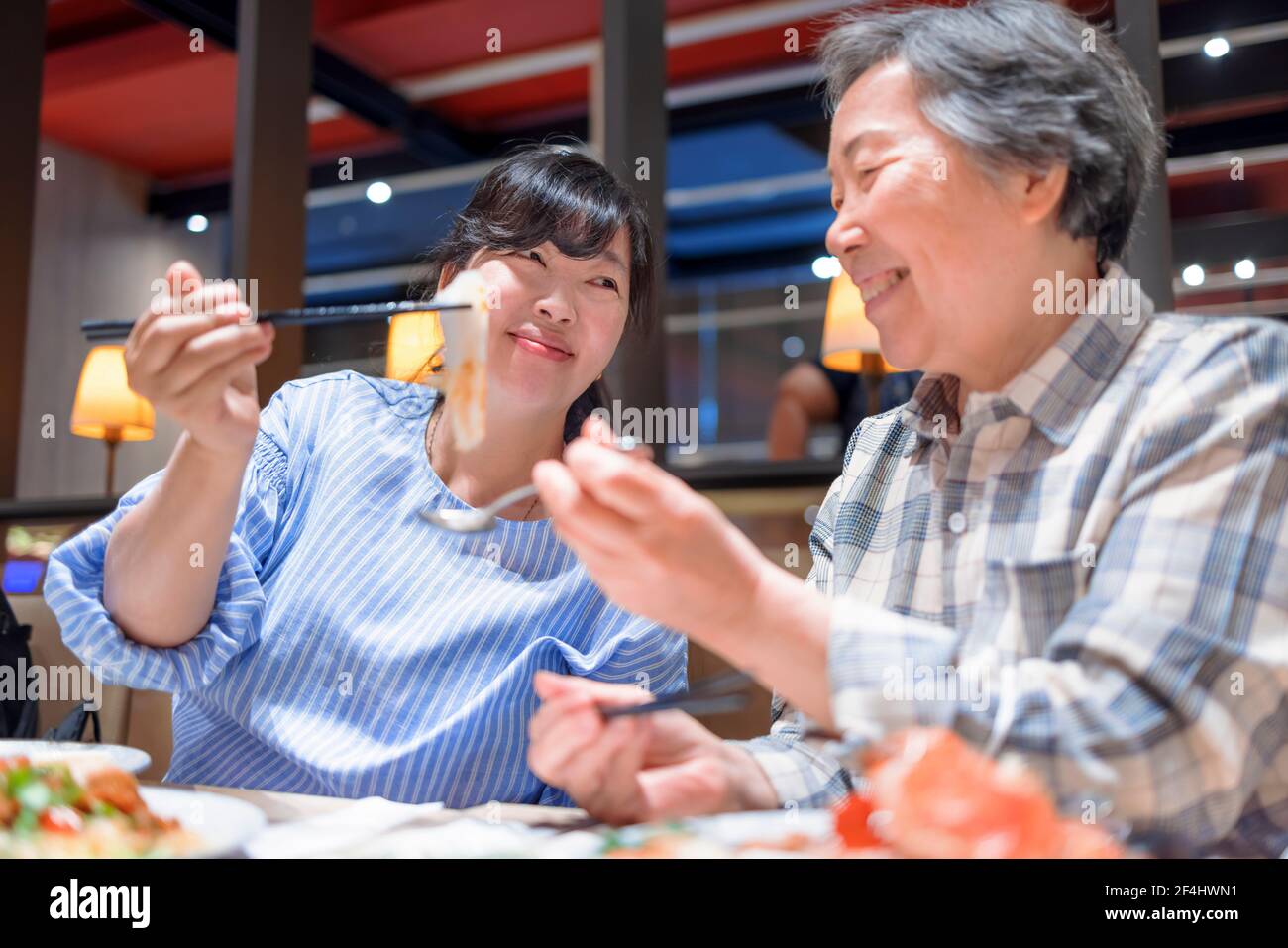 Happy mother and daughter having fun in restaurant Stock Photo - Alamy