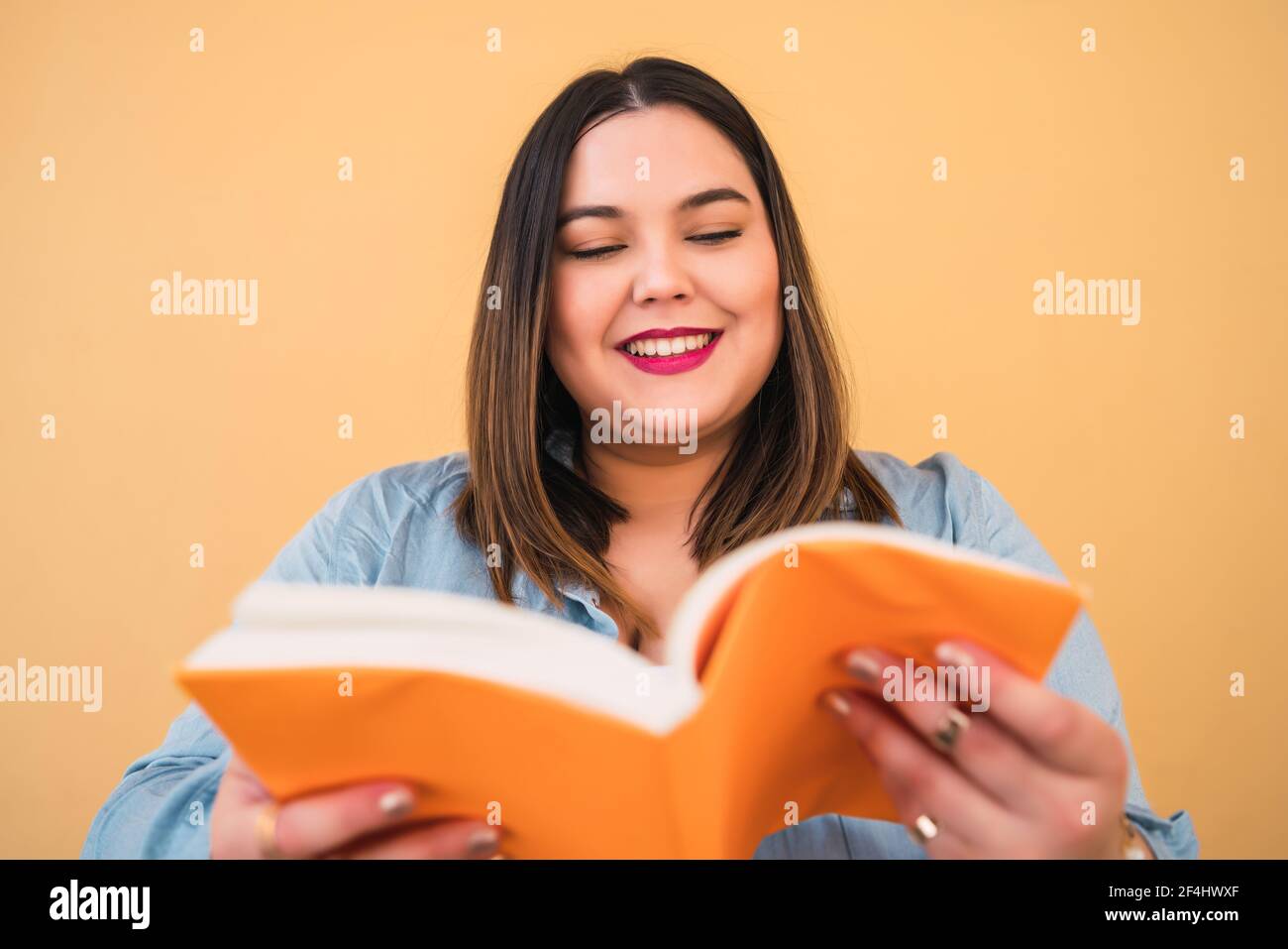 Young plus size woman reading a book Stock Photo - Alamy
