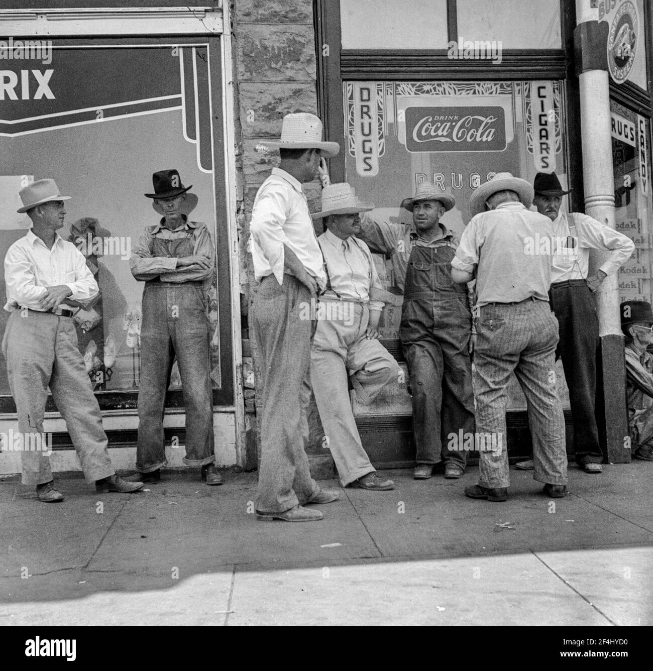 Drought farmers line the shady side of the main street on the town ...