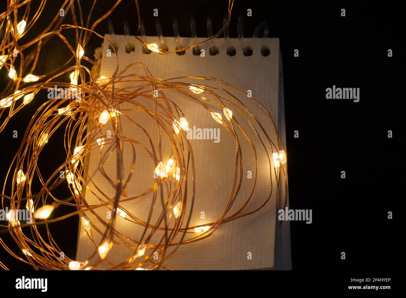 Spiral Notebook or Spring Notebookwith fairy lights Stock Photo - Alamy