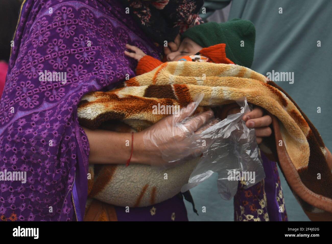 Lahore, Pakistan. 21st Mar, 2021. Pakistani people wearing plastic ...