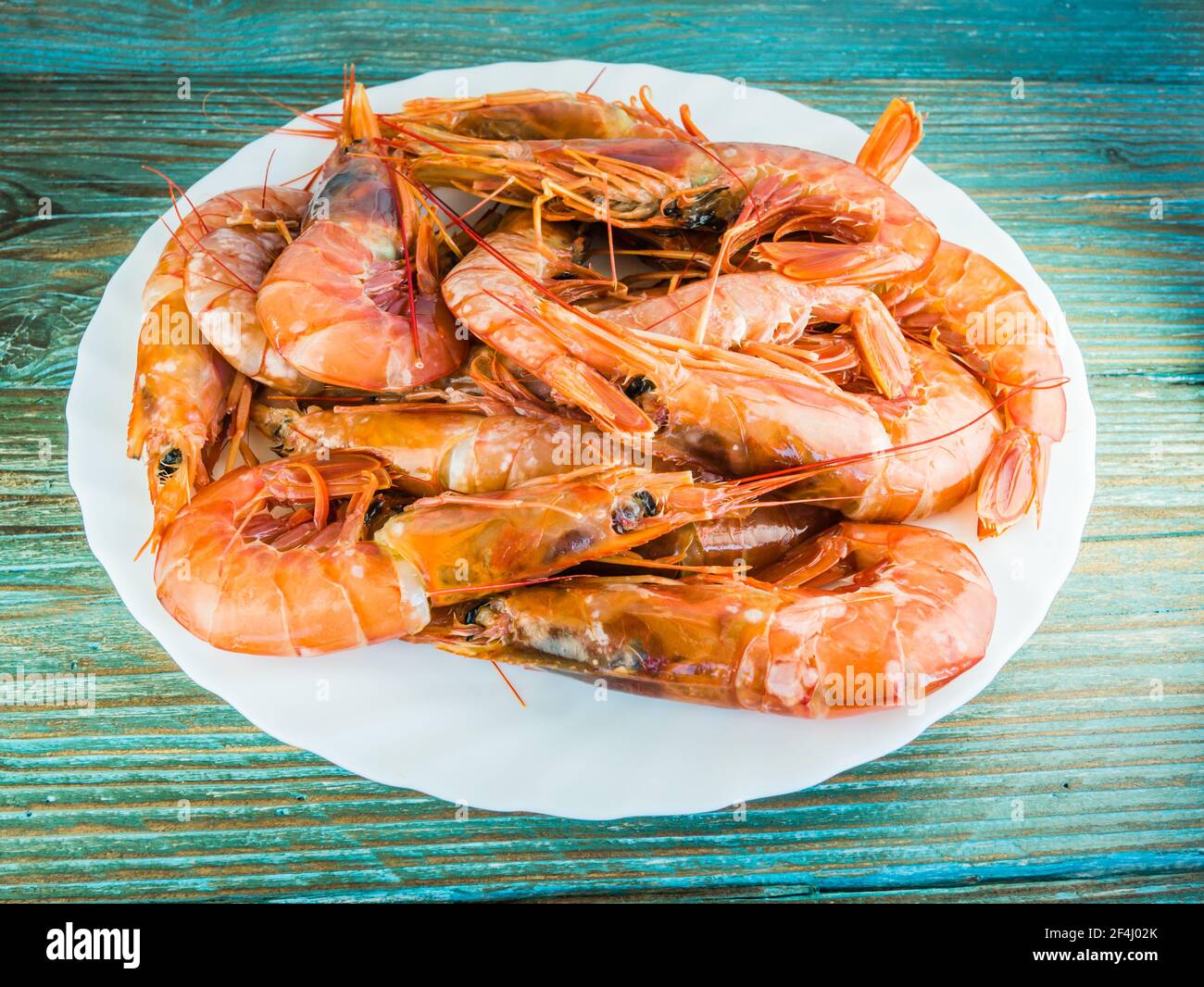 Closeup of the cooked delicious prawns on the plate on the wooden ...