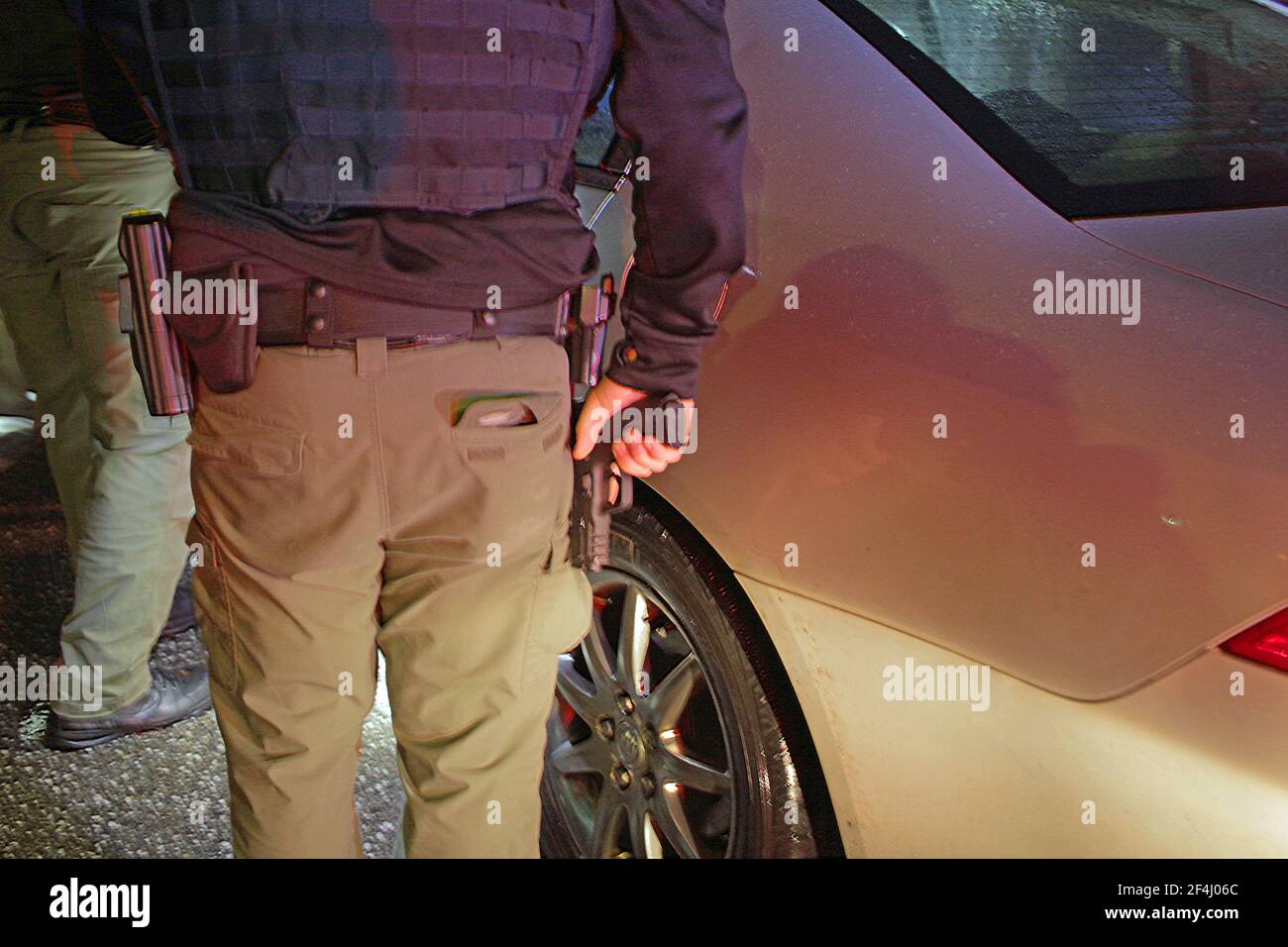 A Detroit police officer has his gun drawn during a traffic stop in ...
