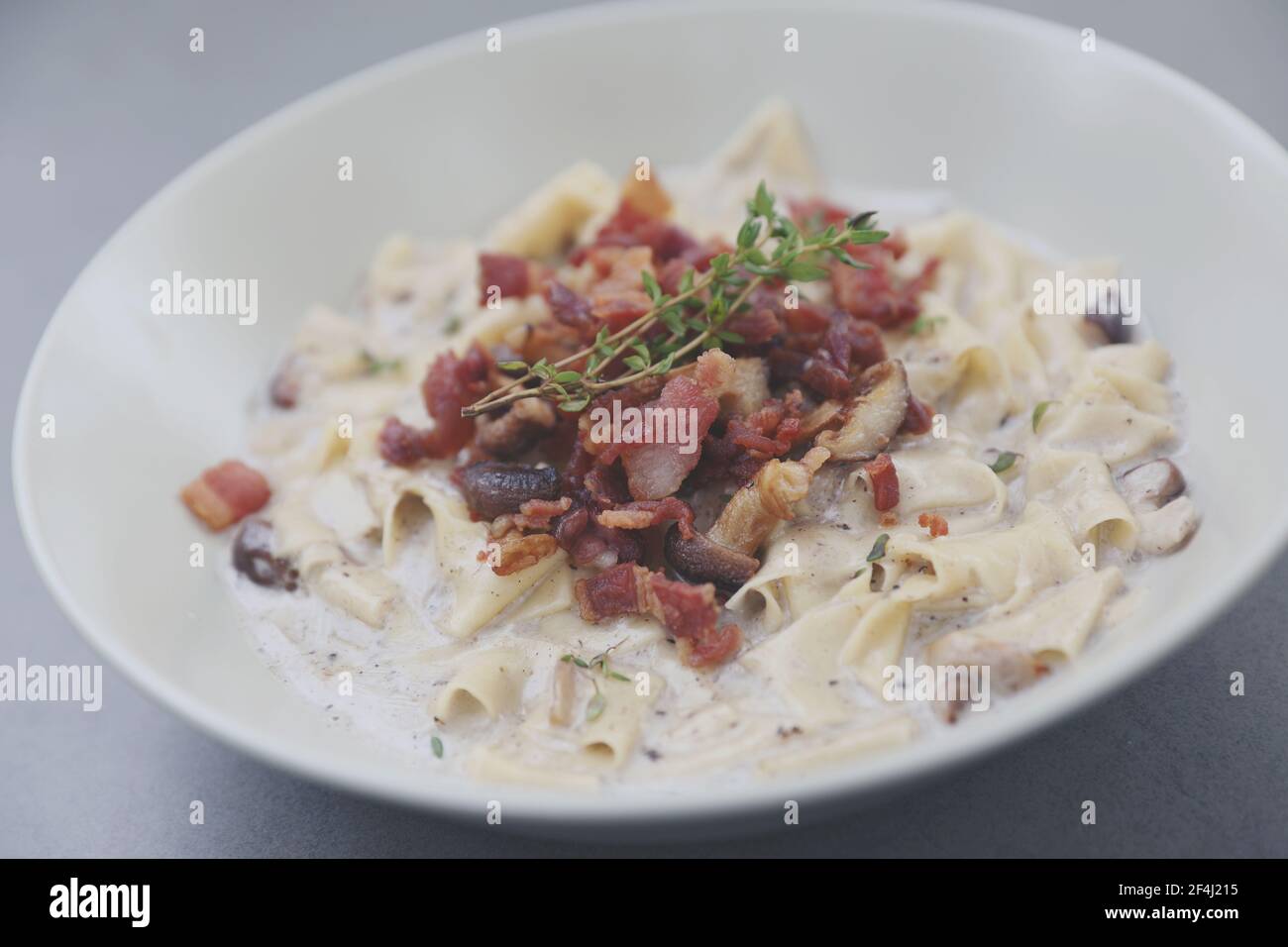 pasta fettuccine alfredo white sauce with ham bacon and mushroom Stock ...