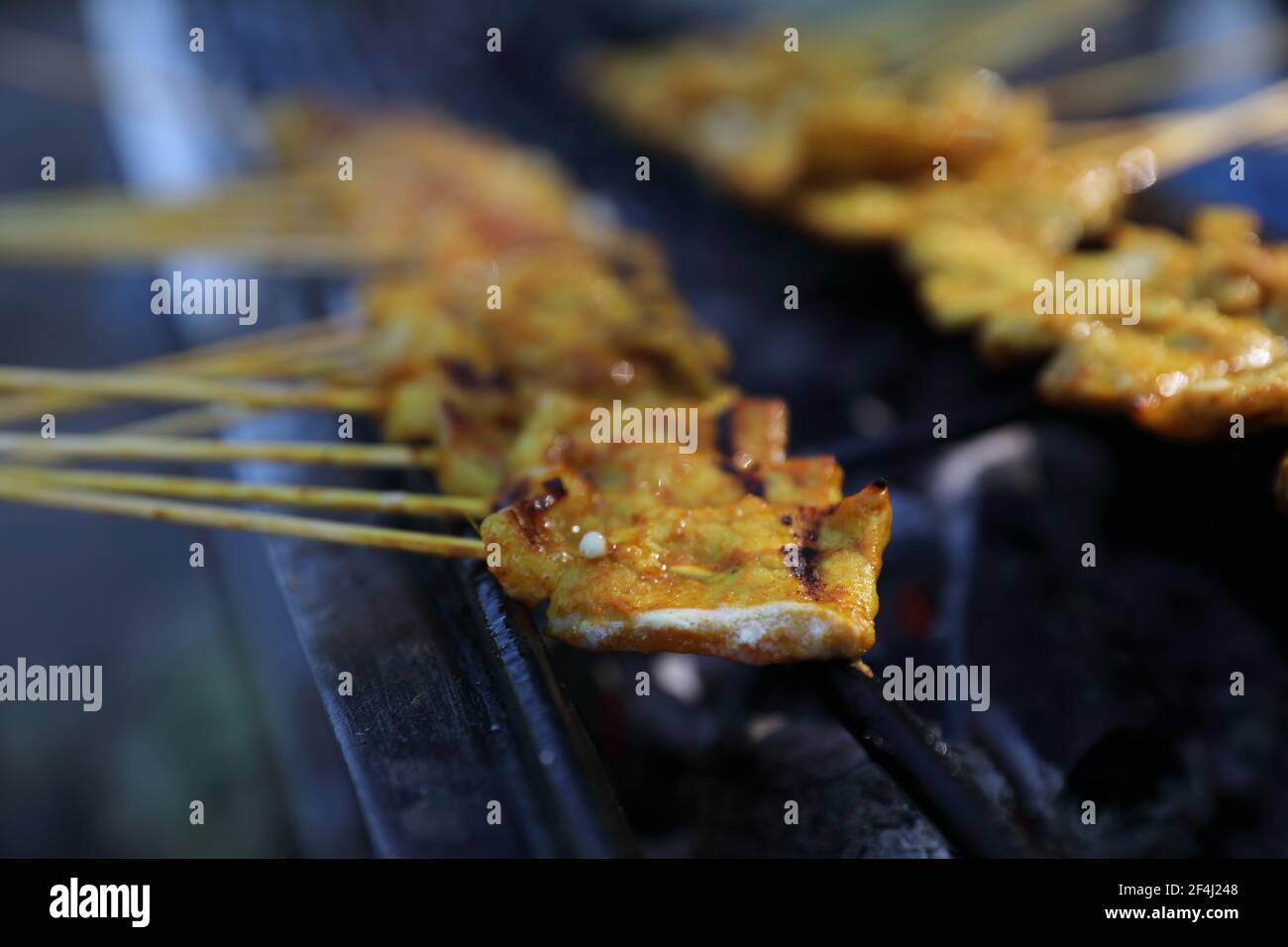 Roasting satays on coal grill , Asian food Stock Photo - Alamy