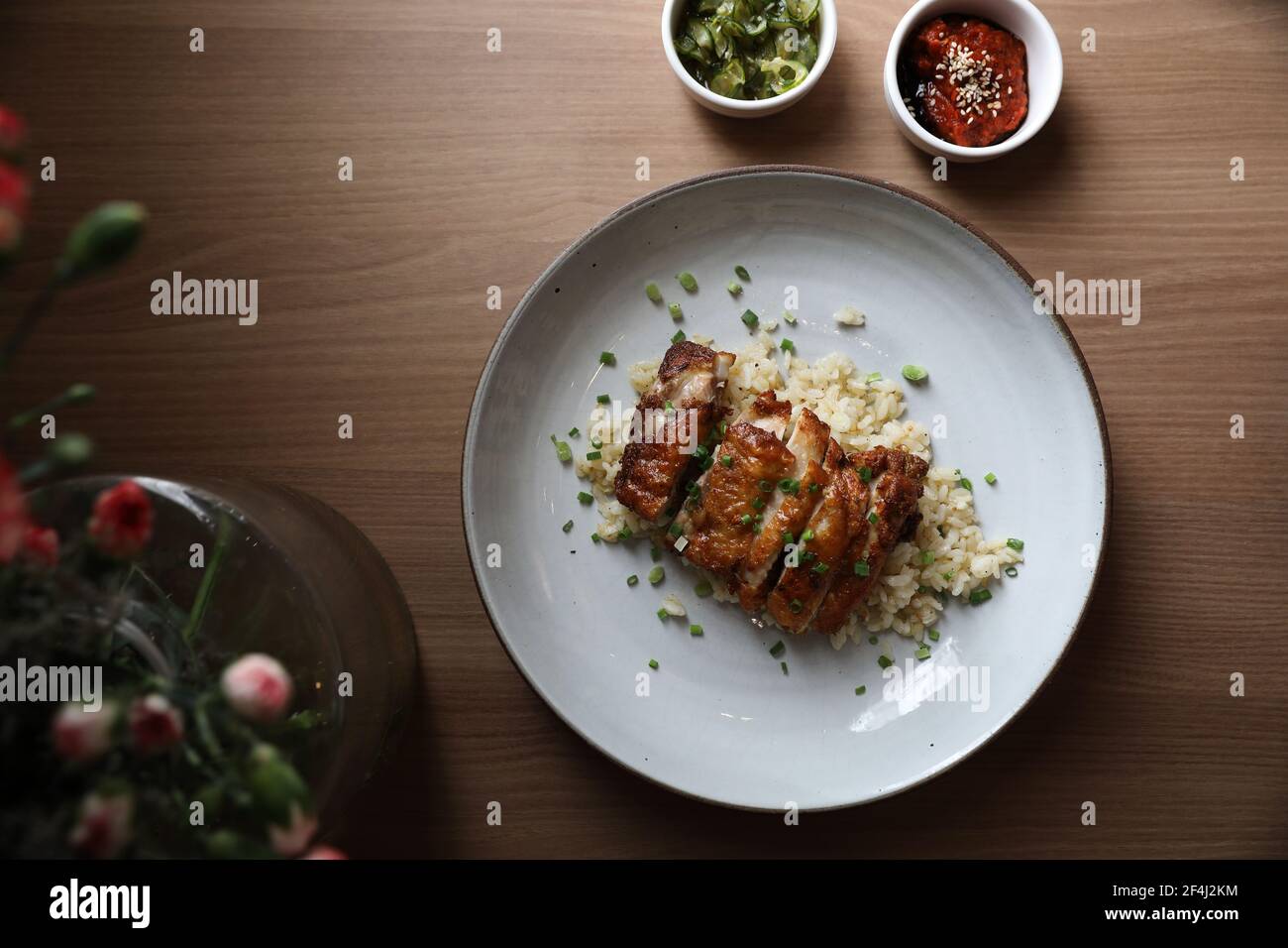 Nasi goreng fried rice with chicken on wood background in top view ...