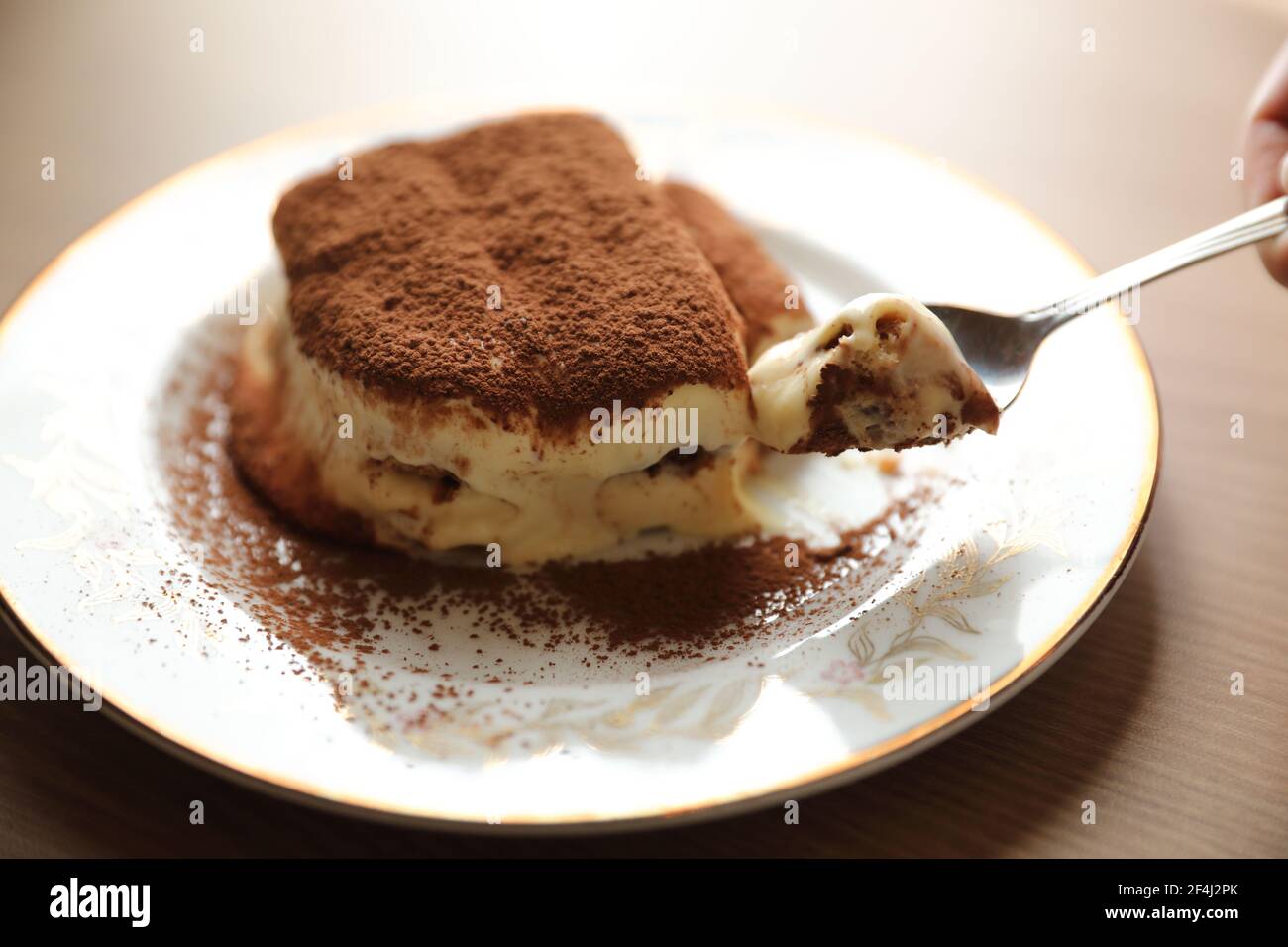Tiramisu cake on wood background Stock Photo - Alamy
