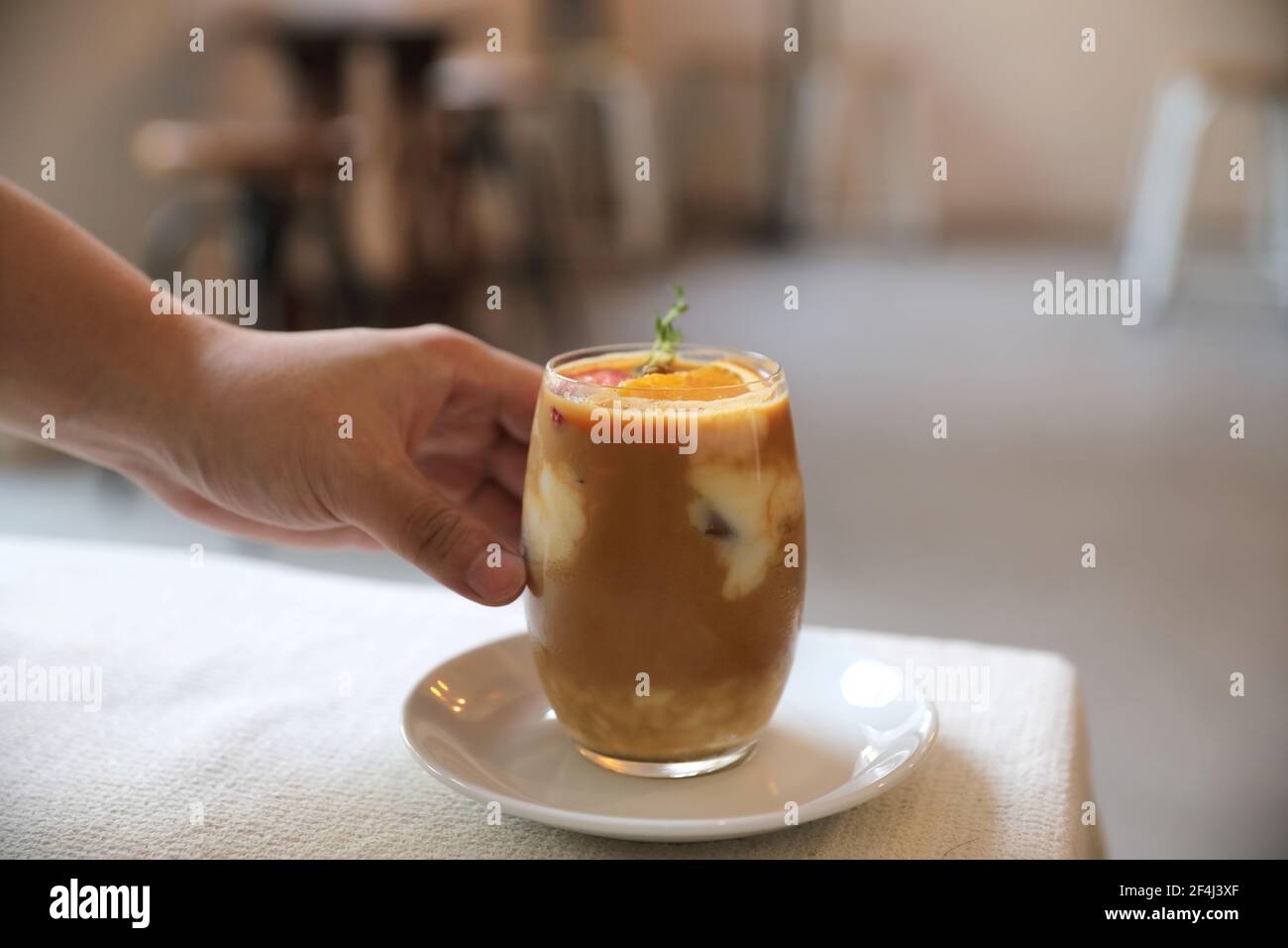 Iced Coffee latte with orange mix in close up Stock Photo - Alamy